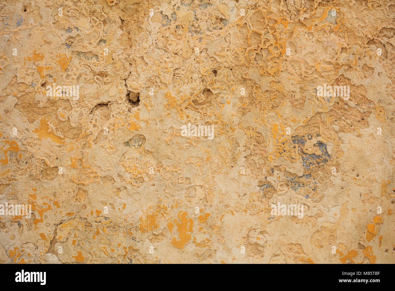Weathered, faded yellow plastered and painted wall background Stock ...