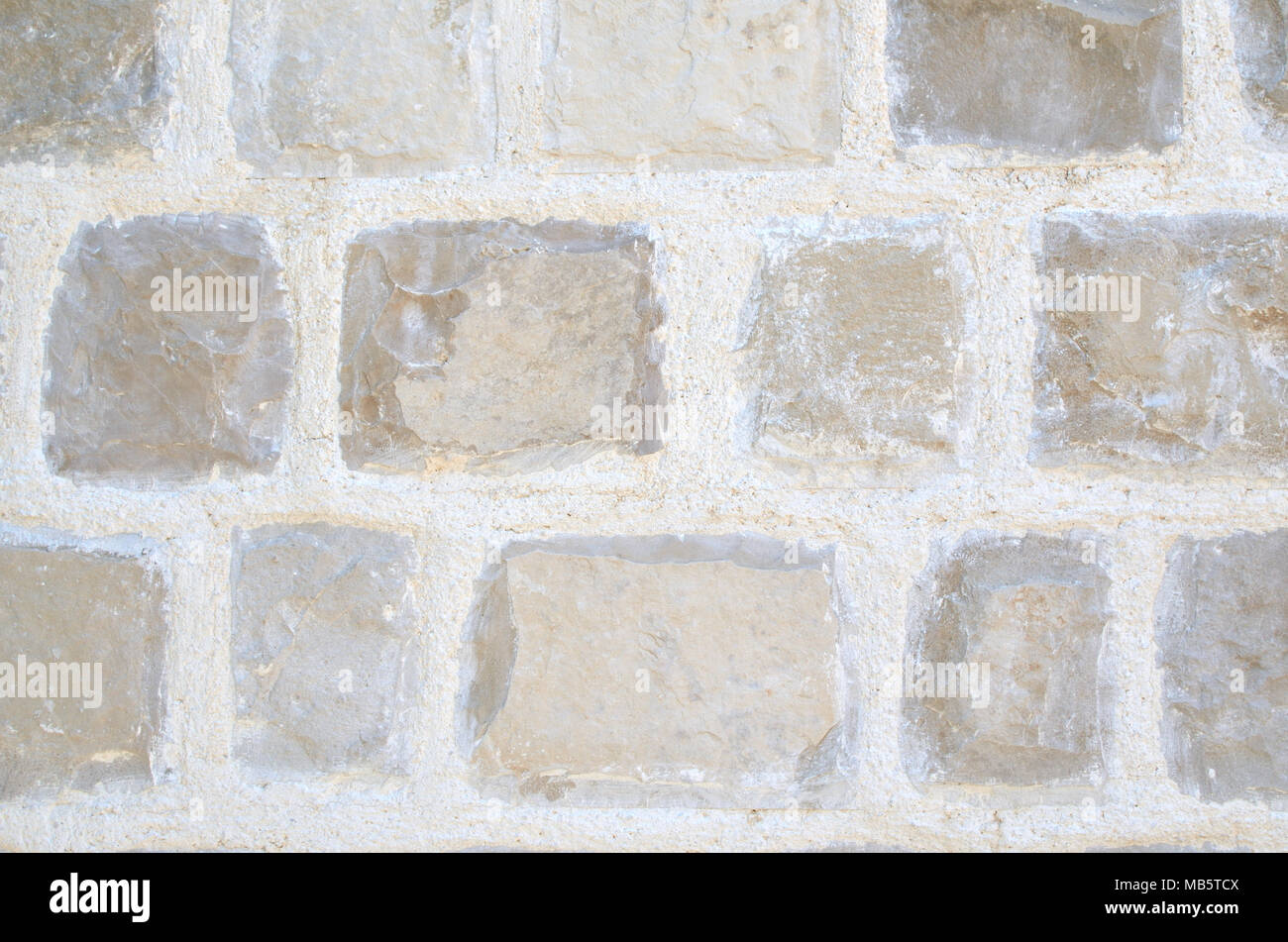 Grunge stone wall surface made of beige and grey stone cubes - suitable ...
