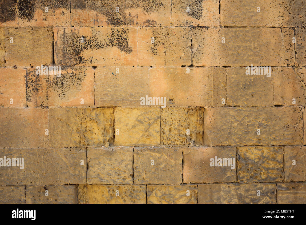 Traditional weathered limestone wall facade background in Malta Stock ...