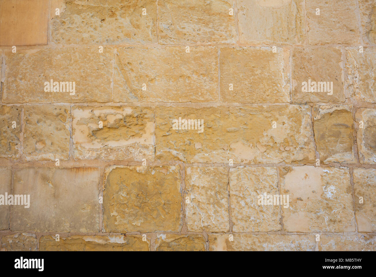 Traditional weathered limestone wall facade background in Malta Stock ...
