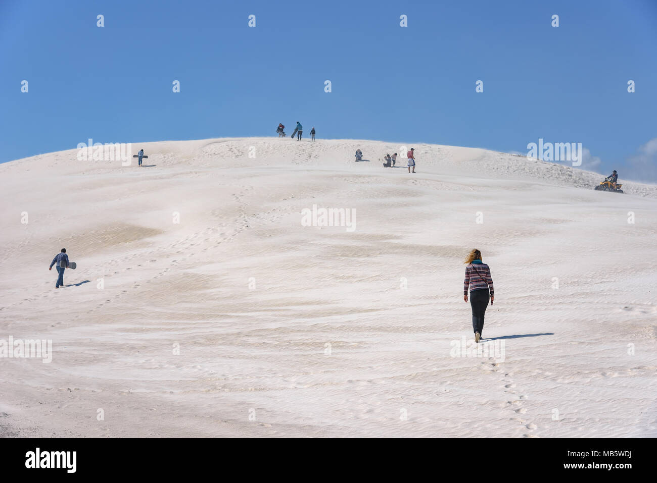People climbing and sandboarding at the Lancelin Sand Dunes in Western ...