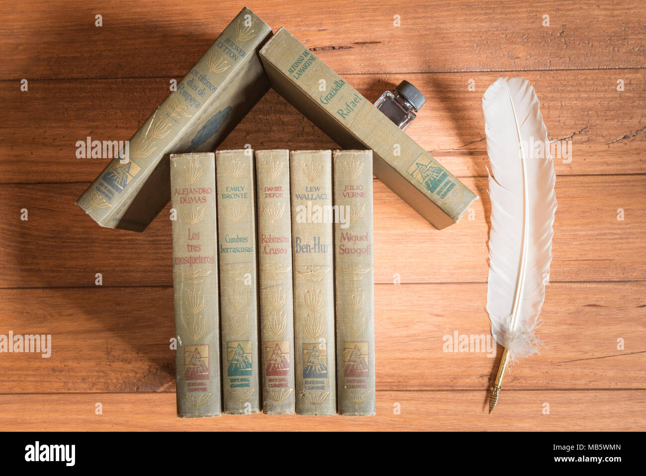 Stack of old books forming the figure of a house, with an inkwell like ...