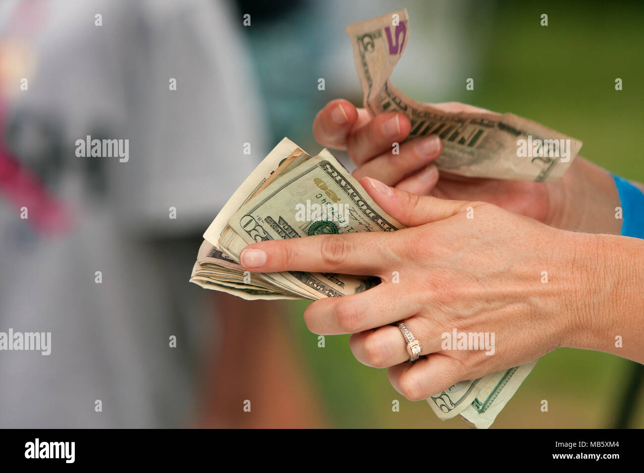 Closeup of a vendor's hands counting money to make change on a ...