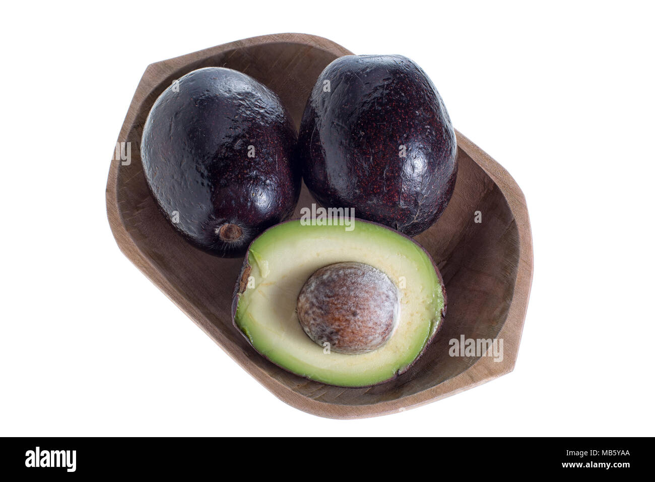 round black avocado variety in Ecuador in a wooden bowl Stock Photo - Alamy