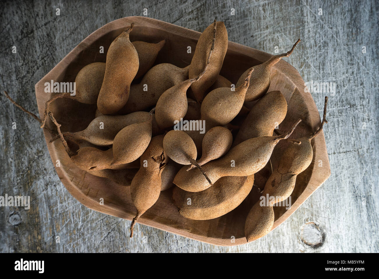 whole tamarind fruits in wooden bowl on rustic background Stock Photo ...