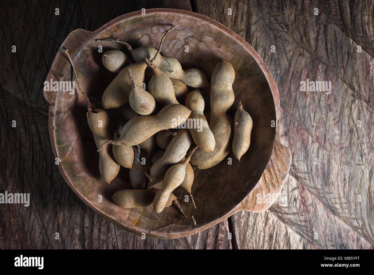 whole tamarind fruits in wooden bowl on rustic background Stock Photo ...