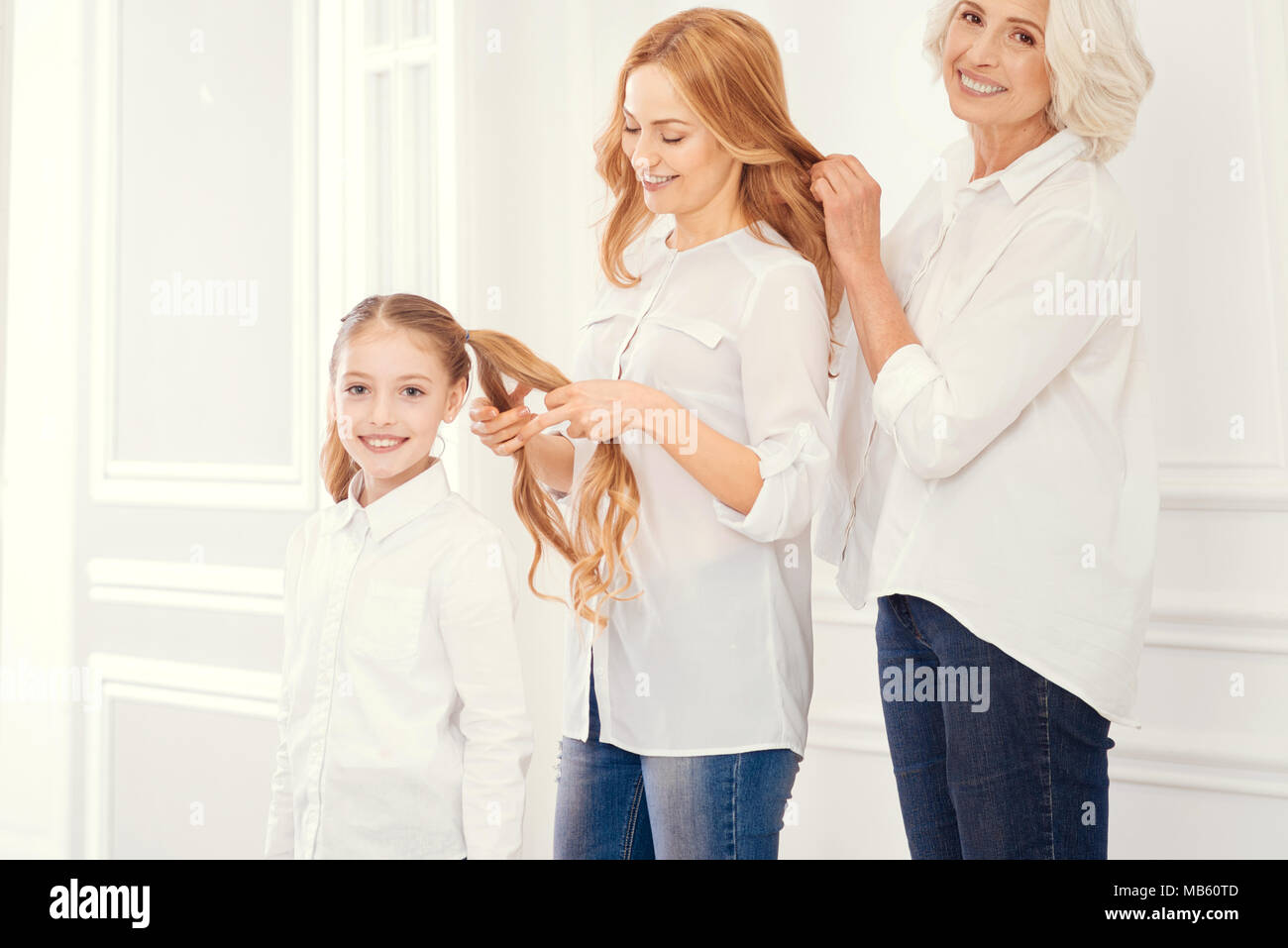 Three generations of women making hairstyles Stock Photo - Alamy
