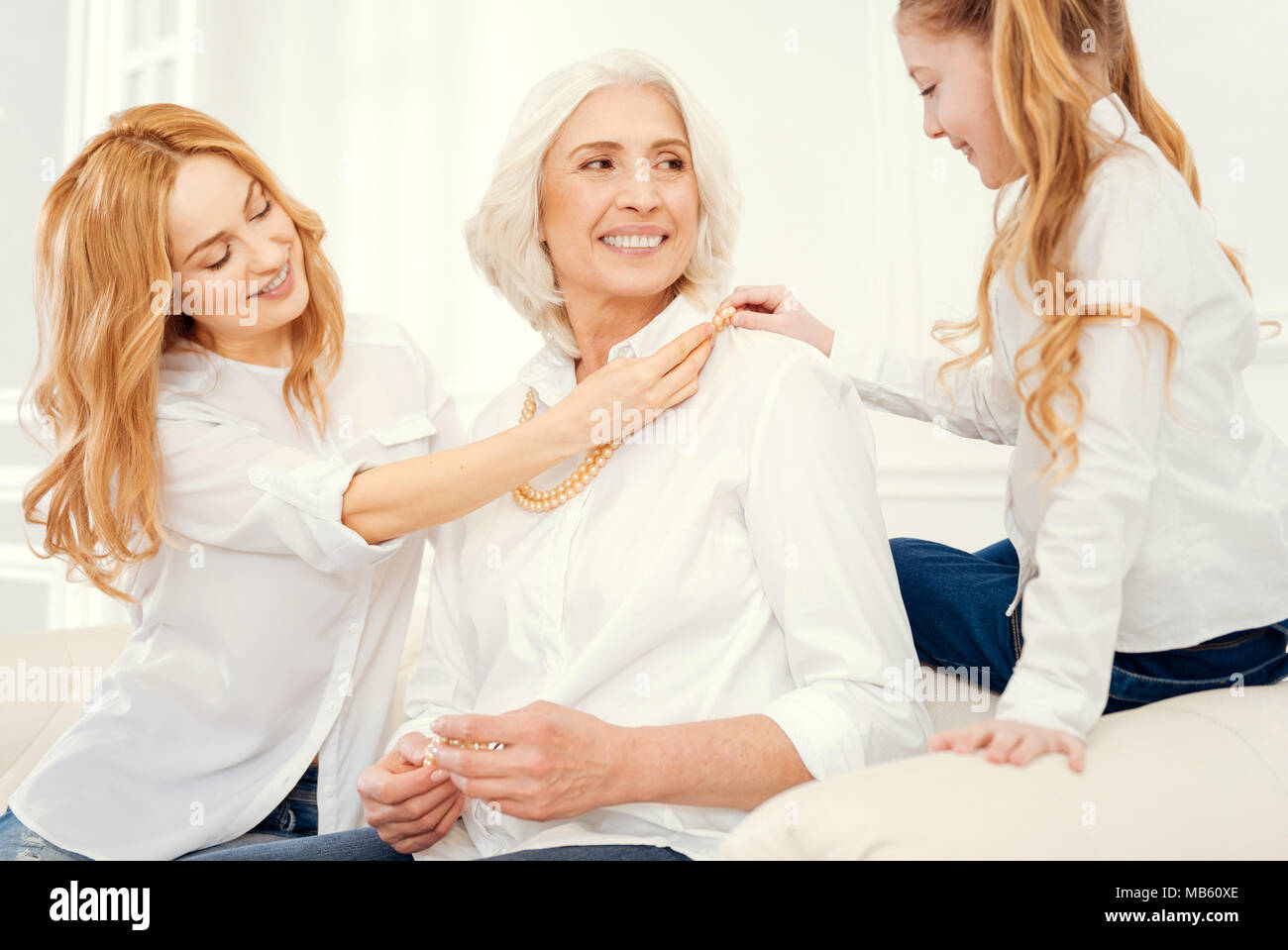 Joyful three generations of women dressing up at home Stock Photo - Alamy