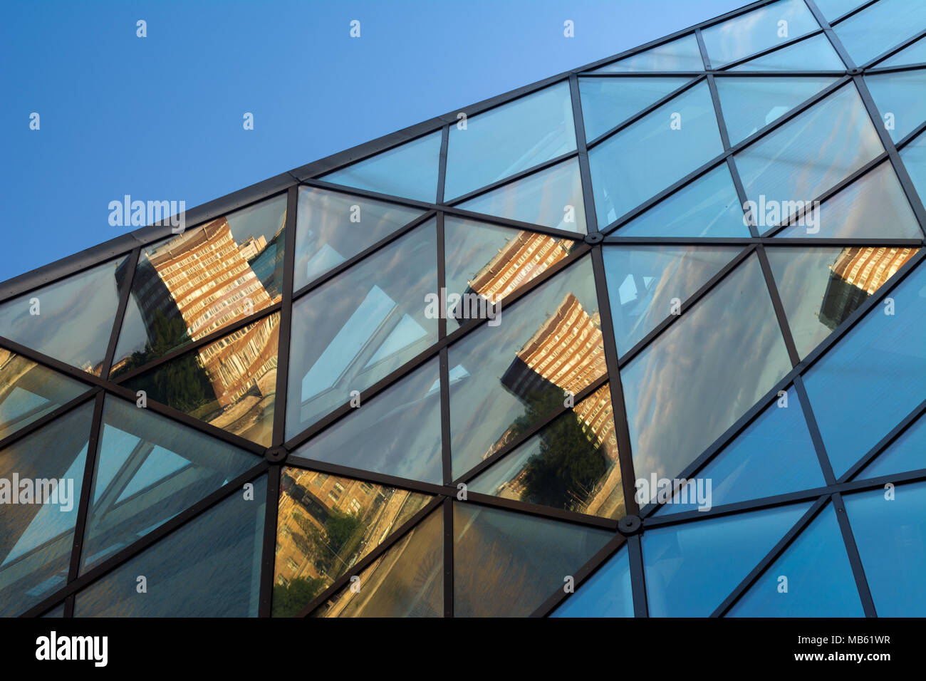 Multiple building reflections in architectural glass structure Stock ...