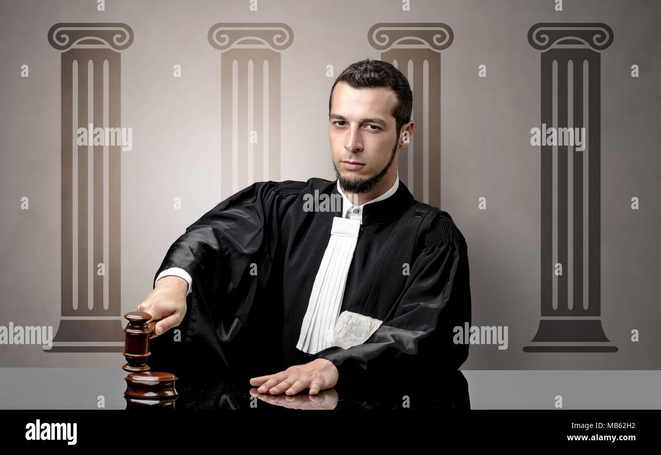 Young judge in front of a courthouse symbol making decision Stock Photo ...