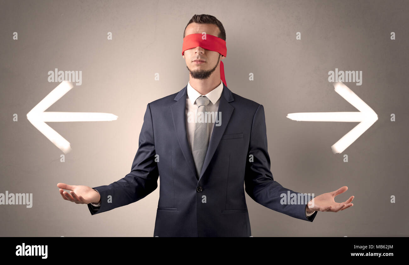 Covered eye businessman choosing between two directions Stock Photo - Alamy