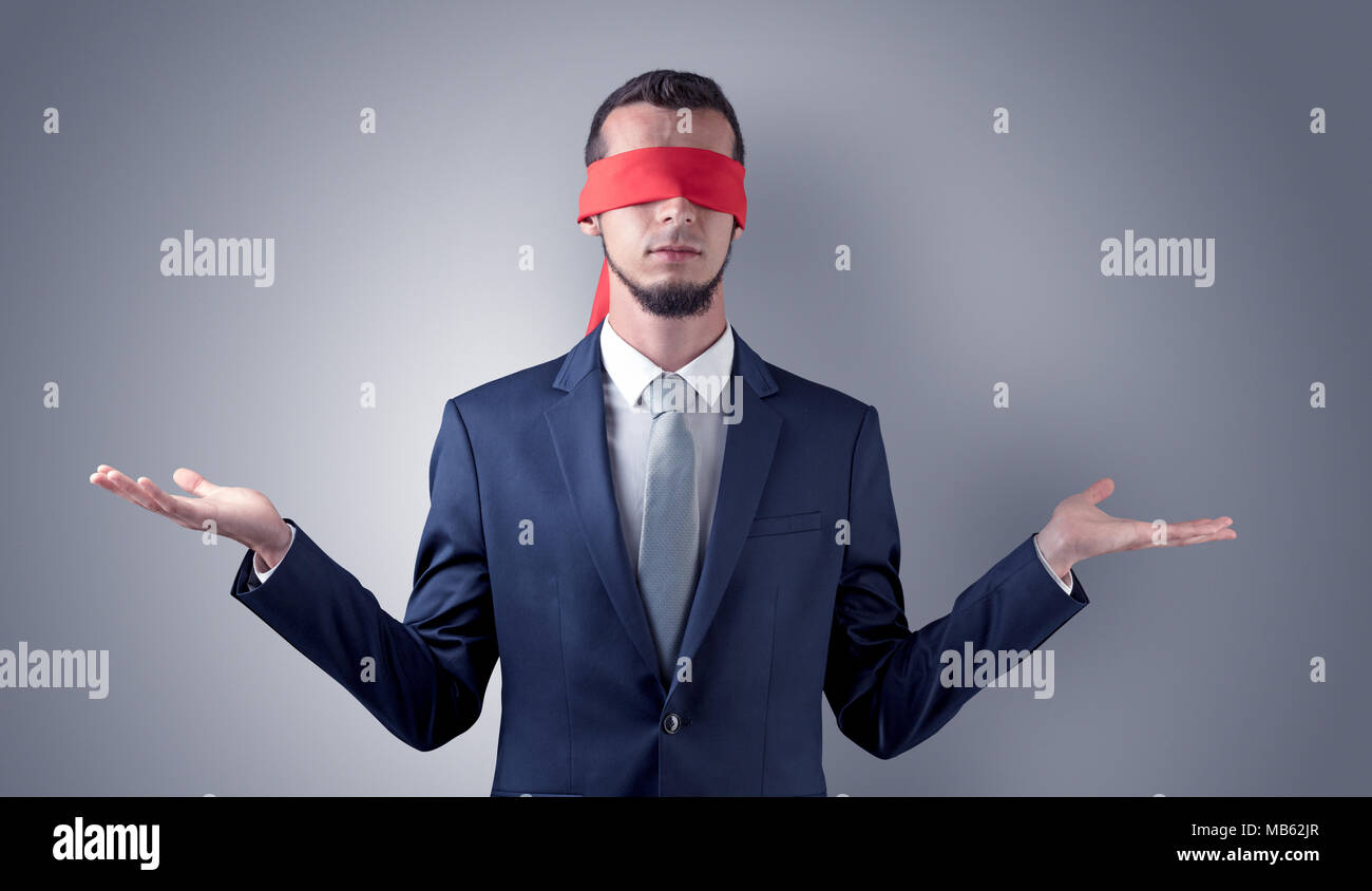 Covered eye, indecisive businessman standing blind in front of a wall ...