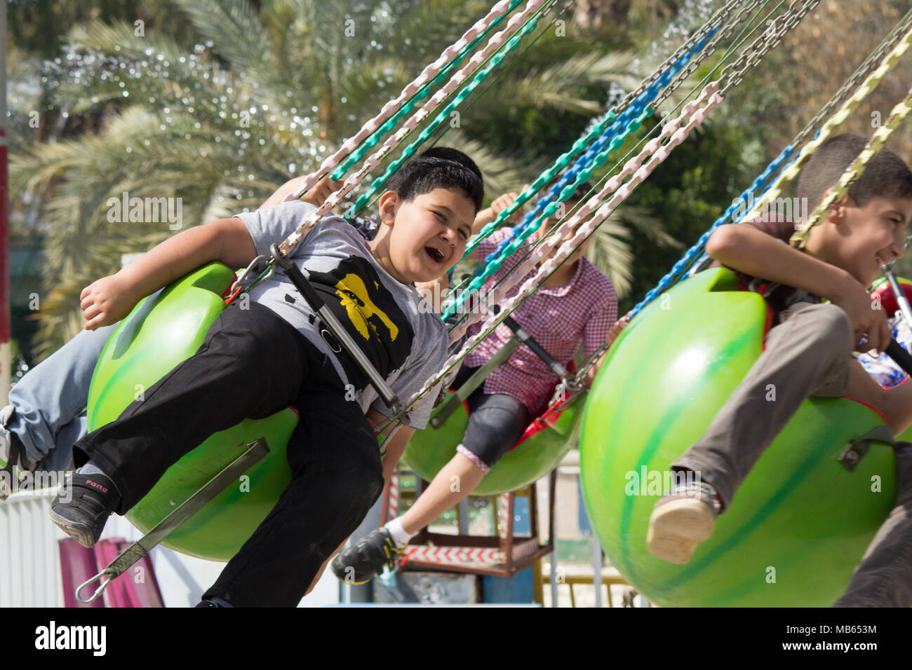 picture for Iraqi kids riding some games in Zawraa park in Baghdad city ...
