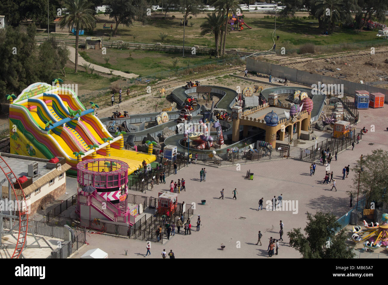 picture for Iraqi kids riding some games in Zawraa park in Baghdad city ...