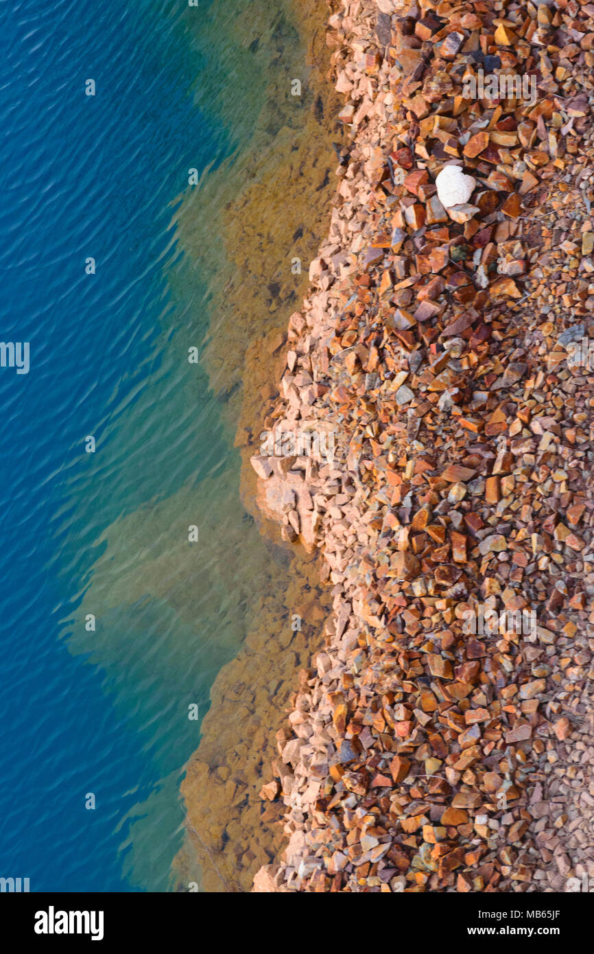 nature backgrounds fresh blue water color on the edge of rocky lake ...