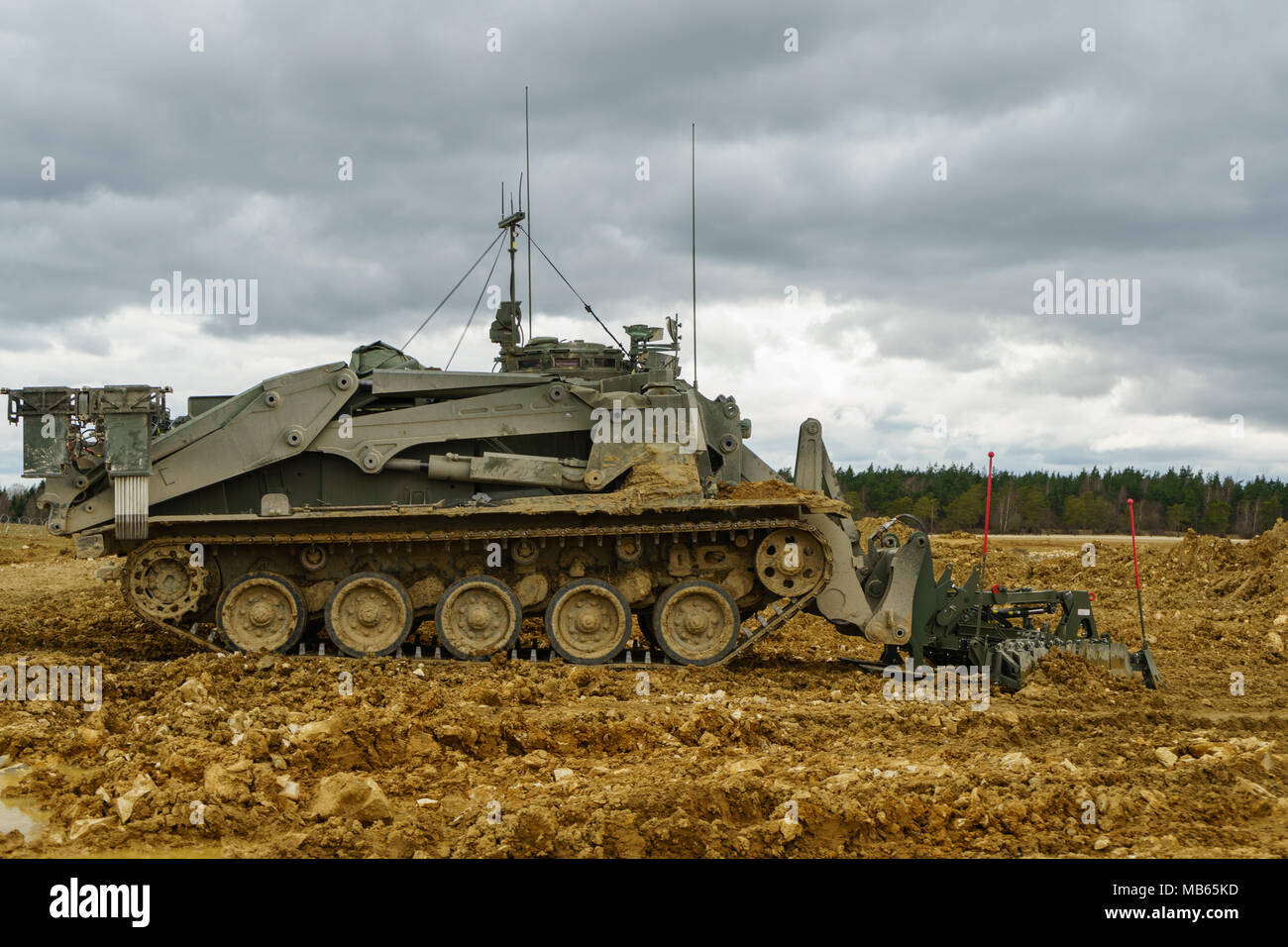 A U.K. Terrier armored digger, operating via remote control, prepares ...