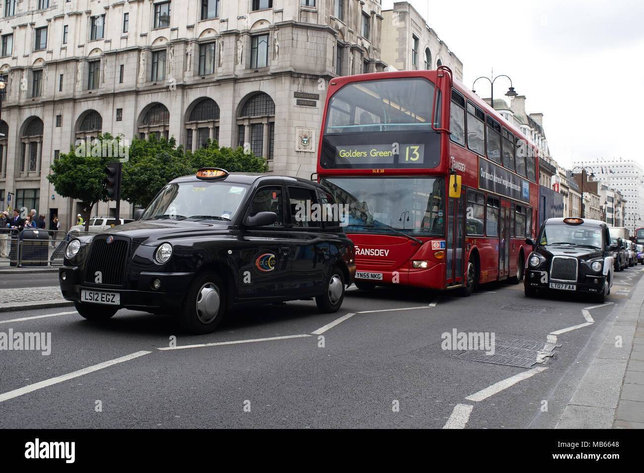 Two London cabs and a city bus, London, England Stock Photo - Alamy