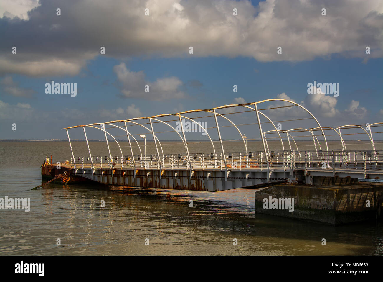 metal rusted structure pier in the water wit blue hazy sky Stock Photo ...