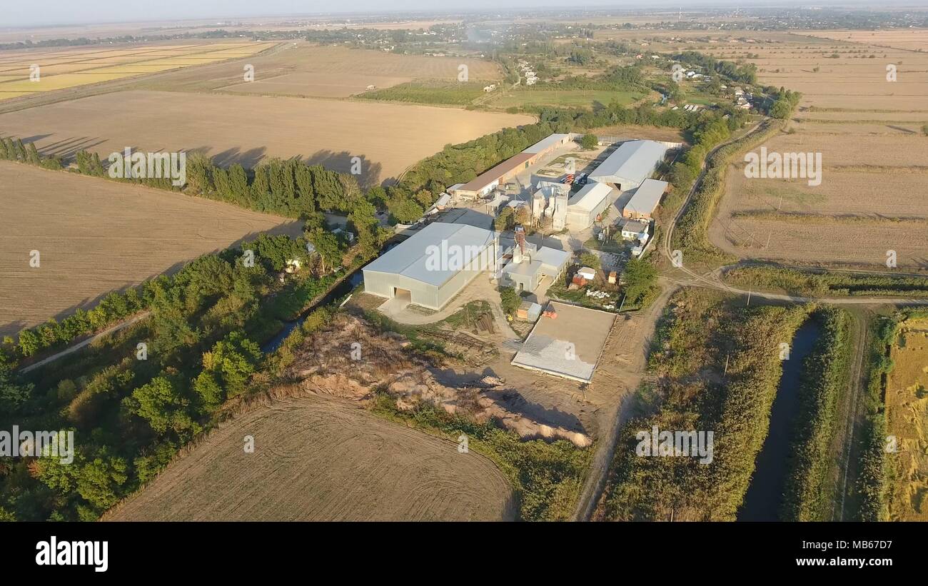 Rice plant. Hangar for storage of grain. A platform for drying and ...