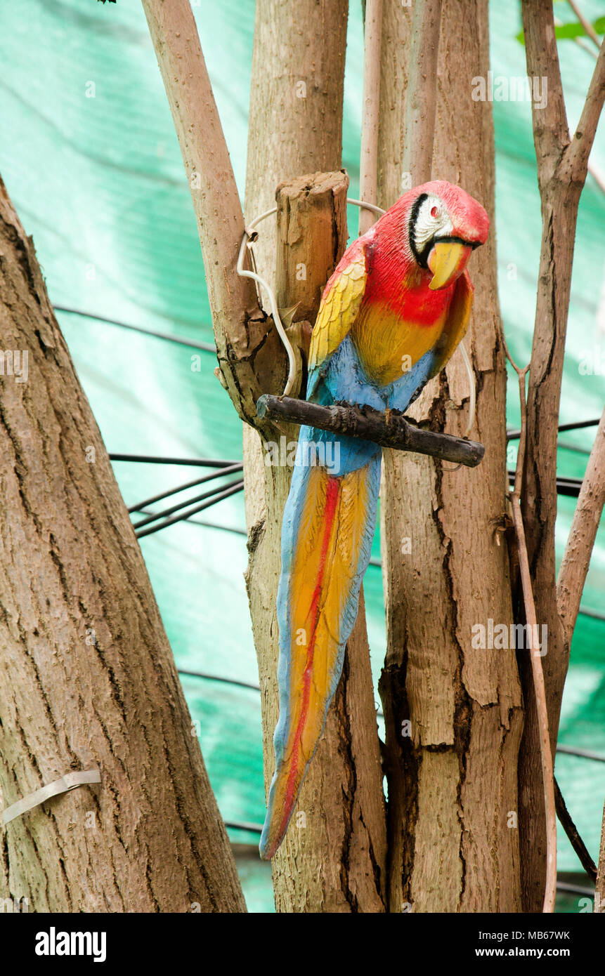 Wooden macaw or parrot birds on tree for decoration in garden Stock ...
