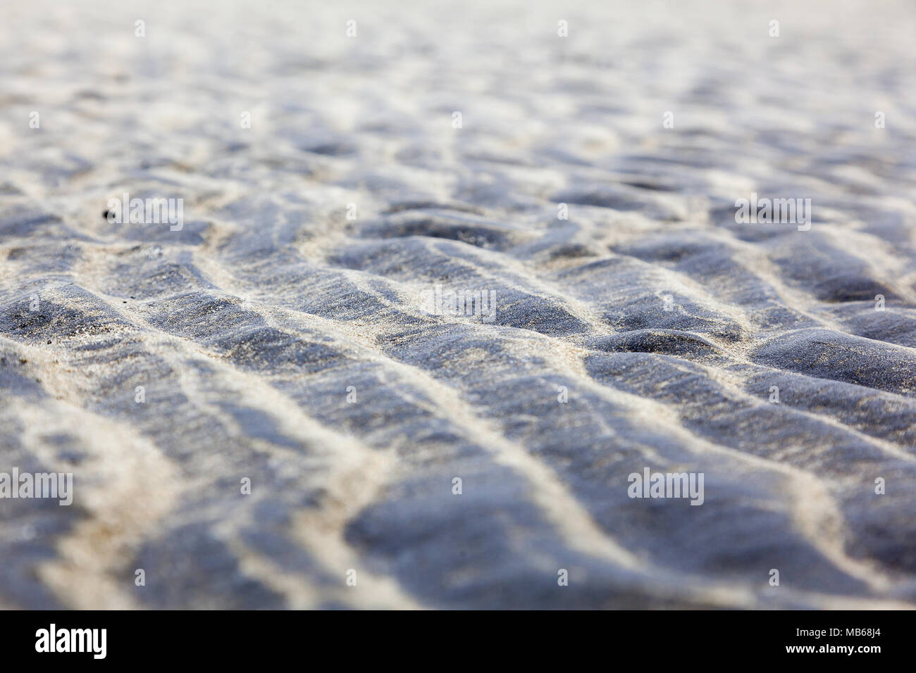 Textures and reliefs formed by water on beach sand Stock Photo - Alamy