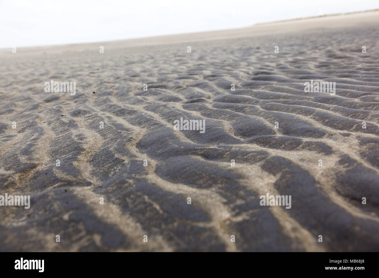 Textures and reliefs formed by water on beach sand Stock Photo - Alamy