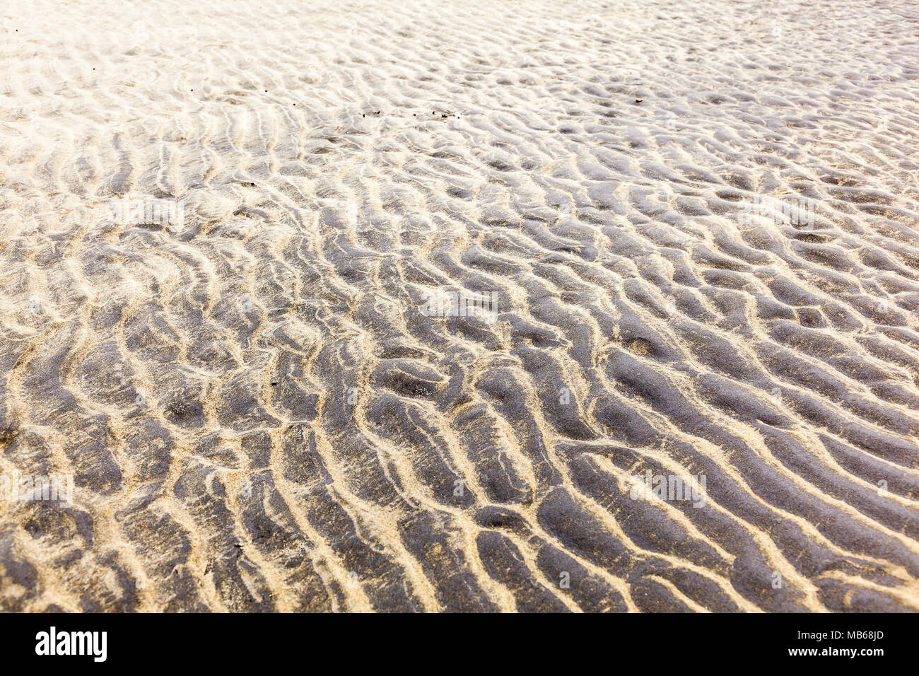 Textures and reliefs formed by water on beach sand Stock Photo - Alamy