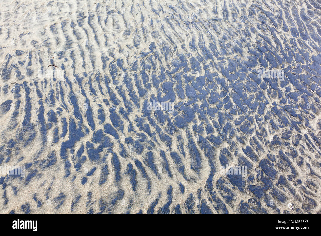 Textures and reliefs formed by water on beach sand Stock Photo - Alamy