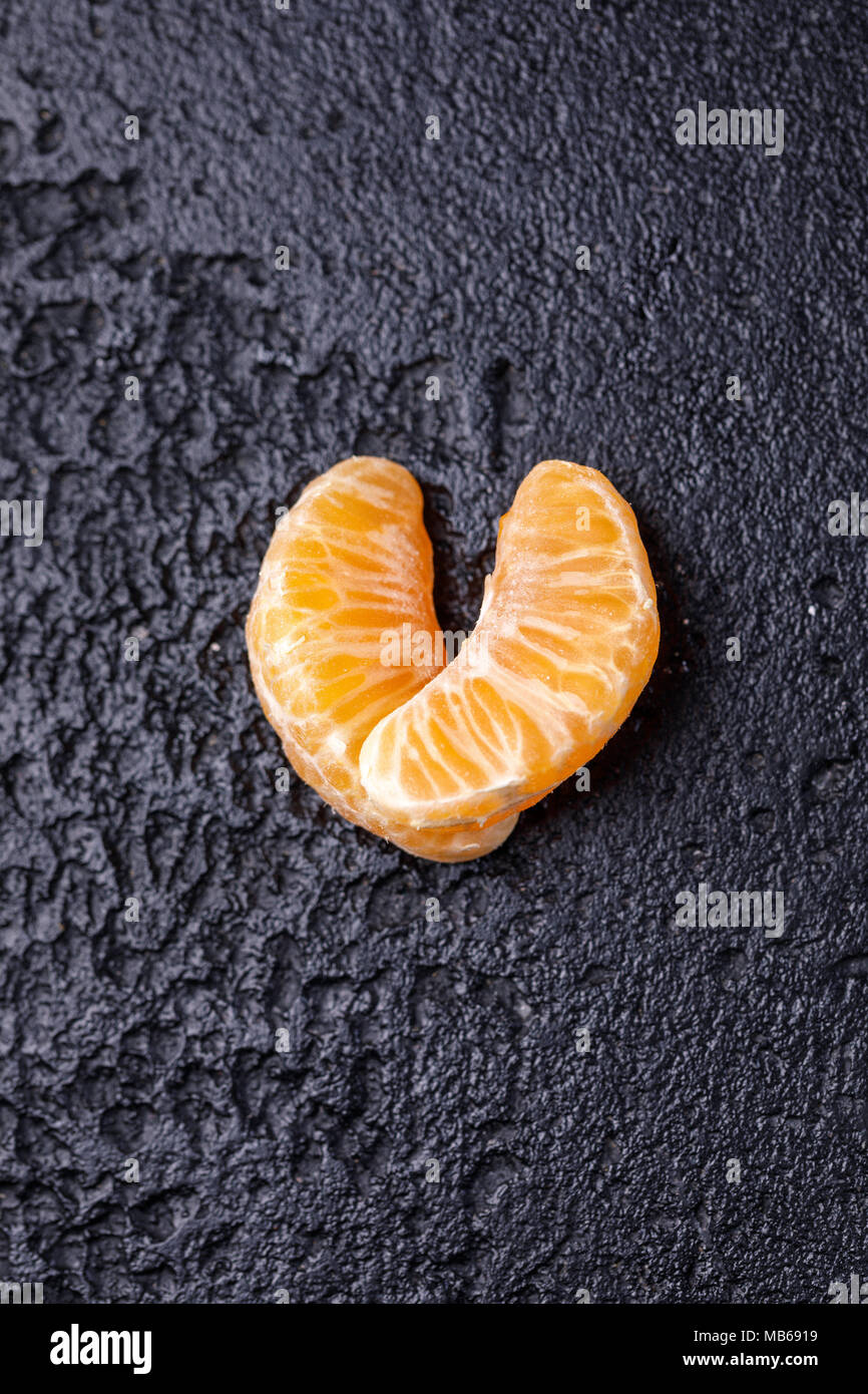 The mandarin slices are lined in the shape of a heart on a black ...