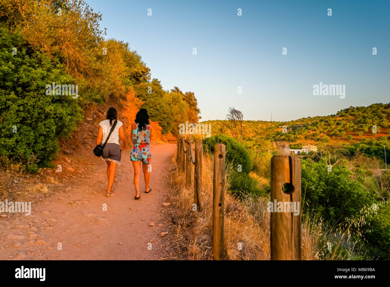 Two woman walking backview hi-res stock photography and images - Alamy