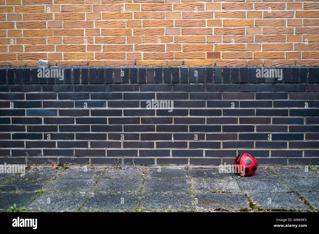 Soccer ball in a courtyard Stock Photo - Alamy
