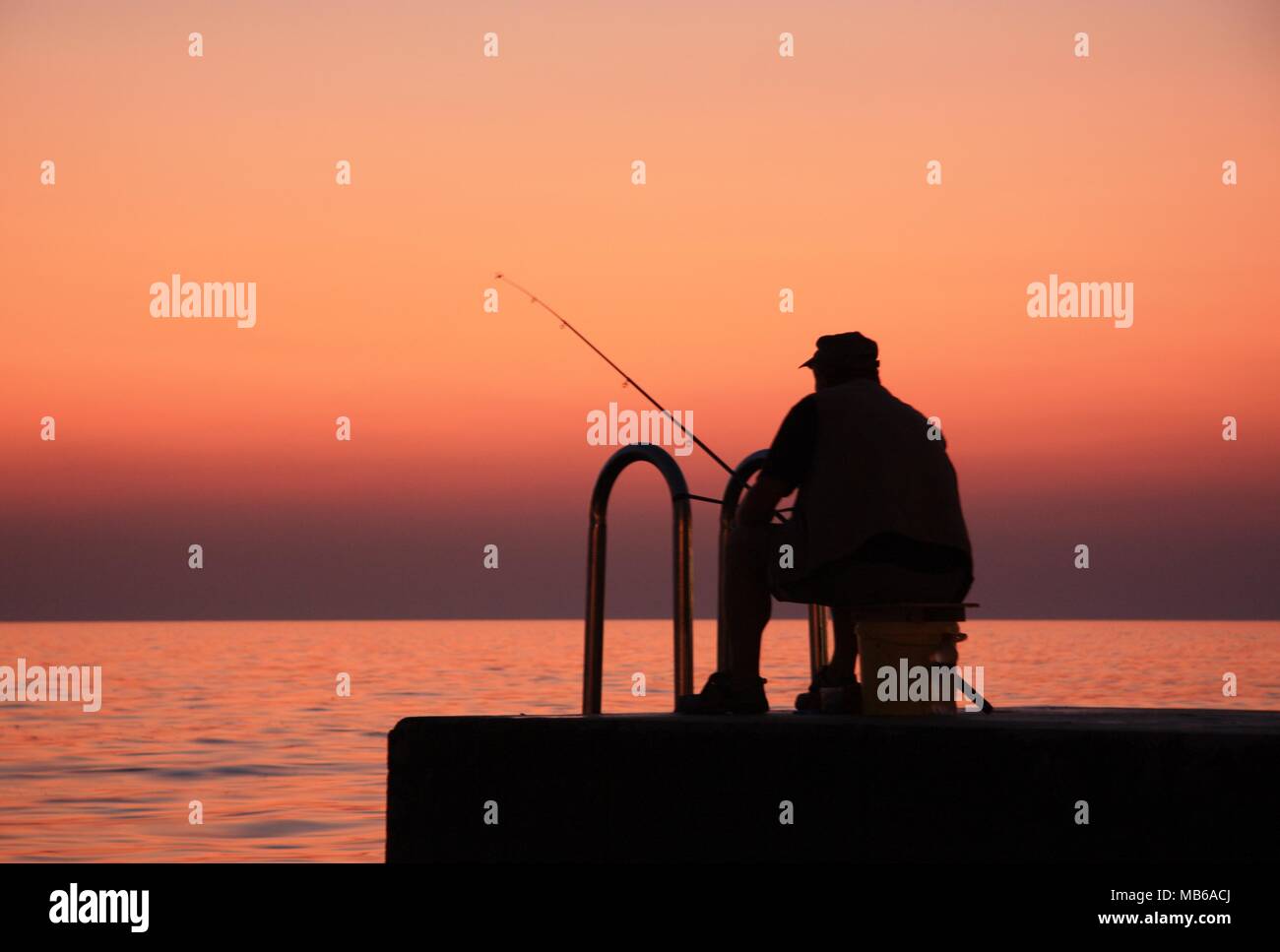 Fishing at Sunset Stock Photo - Alamy