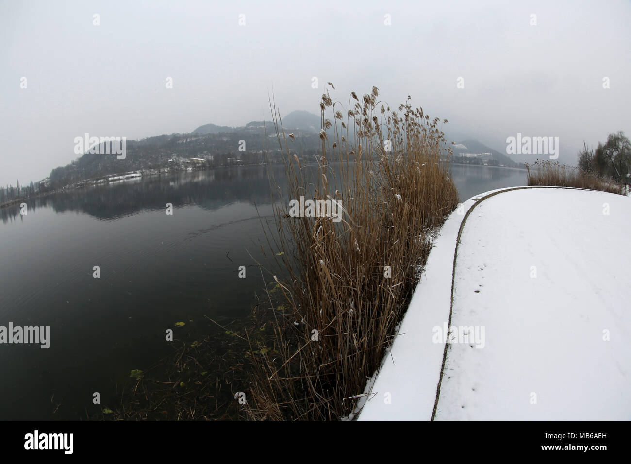 winter landscape with snow and lake called Lago di Fimon in Northern ...