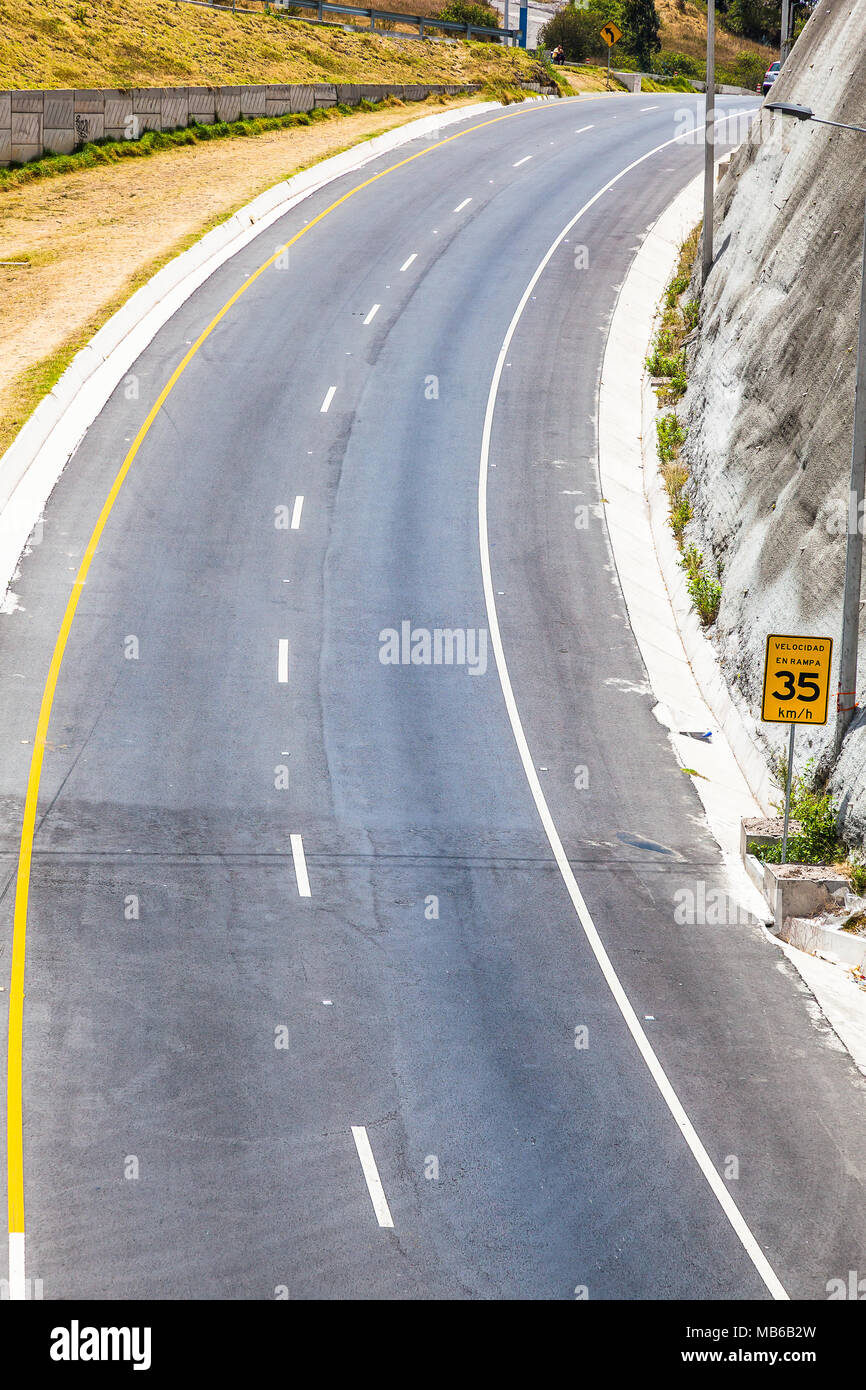 Segments of newly constructed asphalt highway with its white and yellow ...