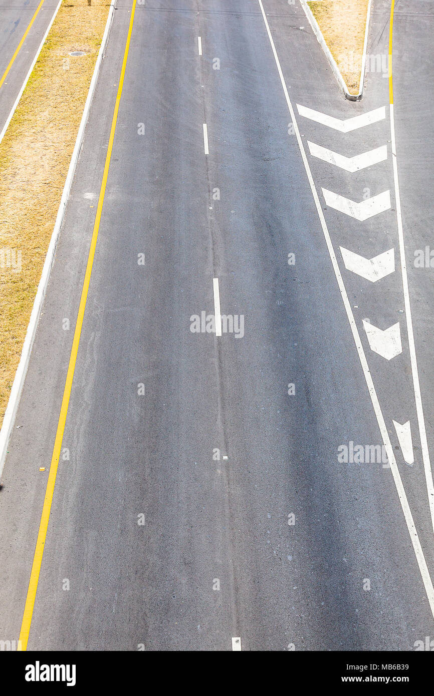 Segments of newly constructed asphalt highway with its white and yellow ...