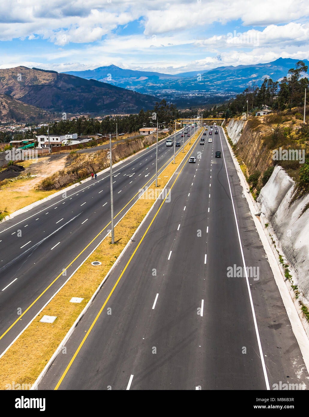 Segments of newly constructed asphalt highway with its white and yellow ...