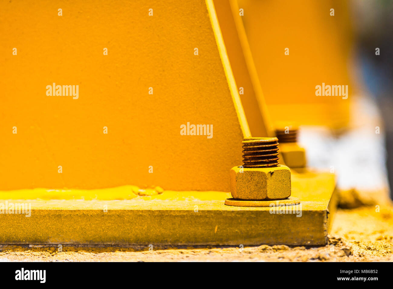 Steel anchors with base, nuts and bolts painted yellow Stock Photo - Alamy