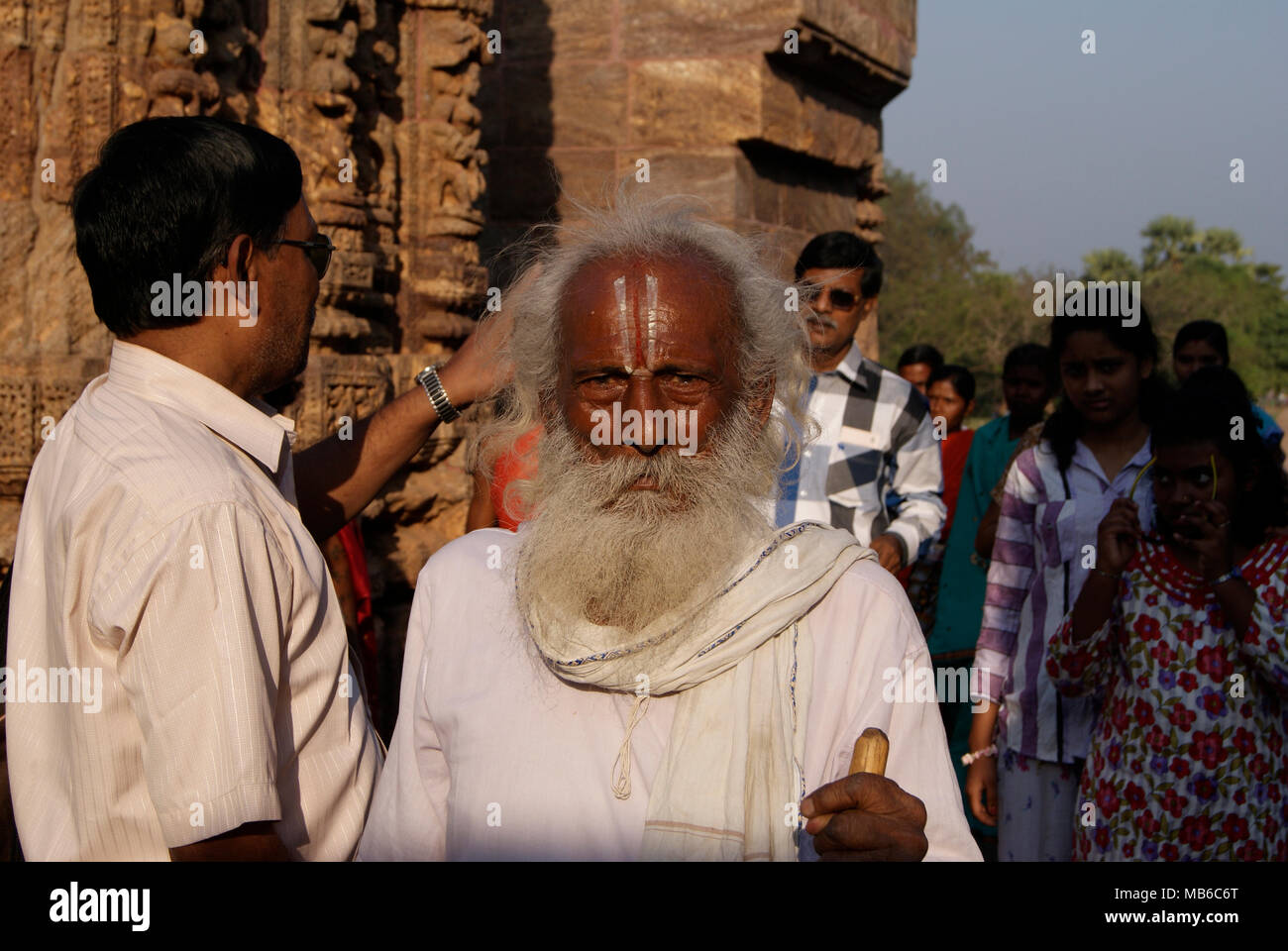 A spiritual Indian old man and peoples entered into a temple in India ...