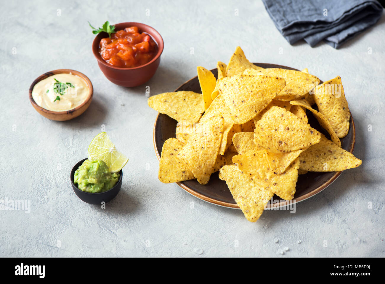 Nachos chips and assorted dip sauces. Tortilla corn nachos chips with ...