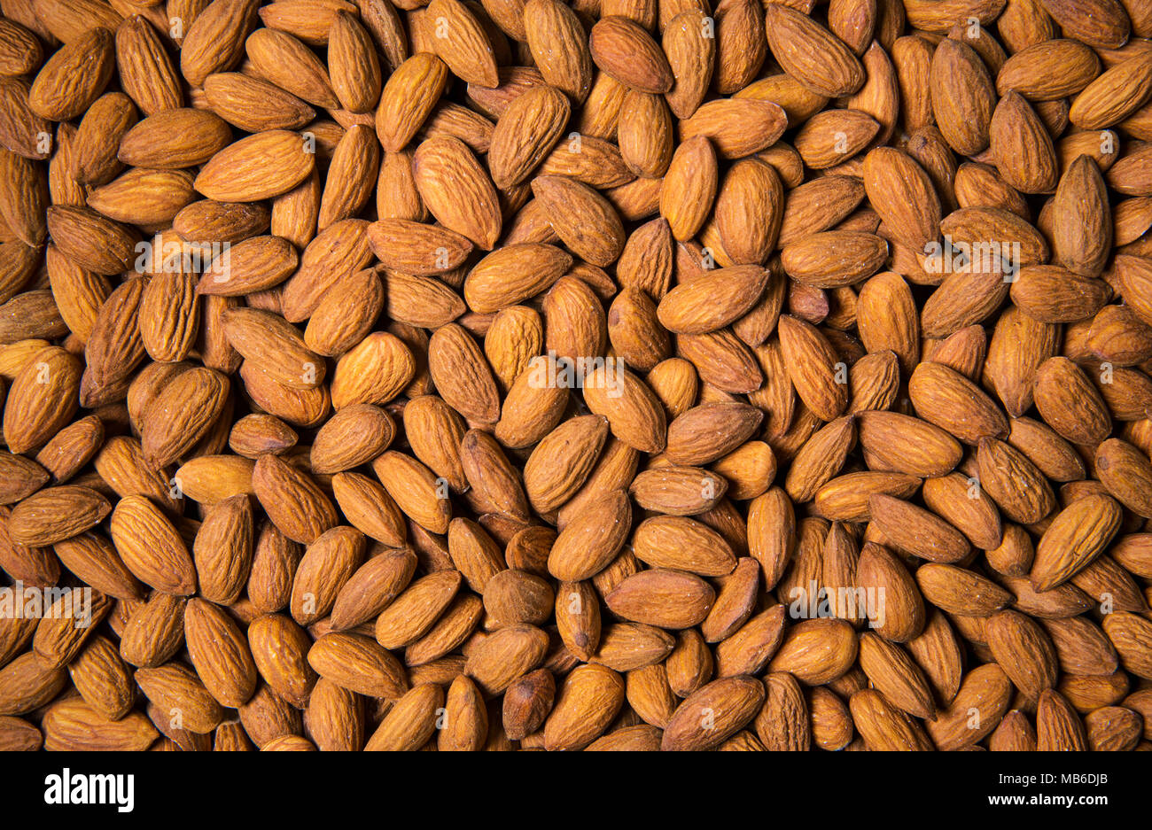 Almond seeds as food background Stock Photo - Alamy