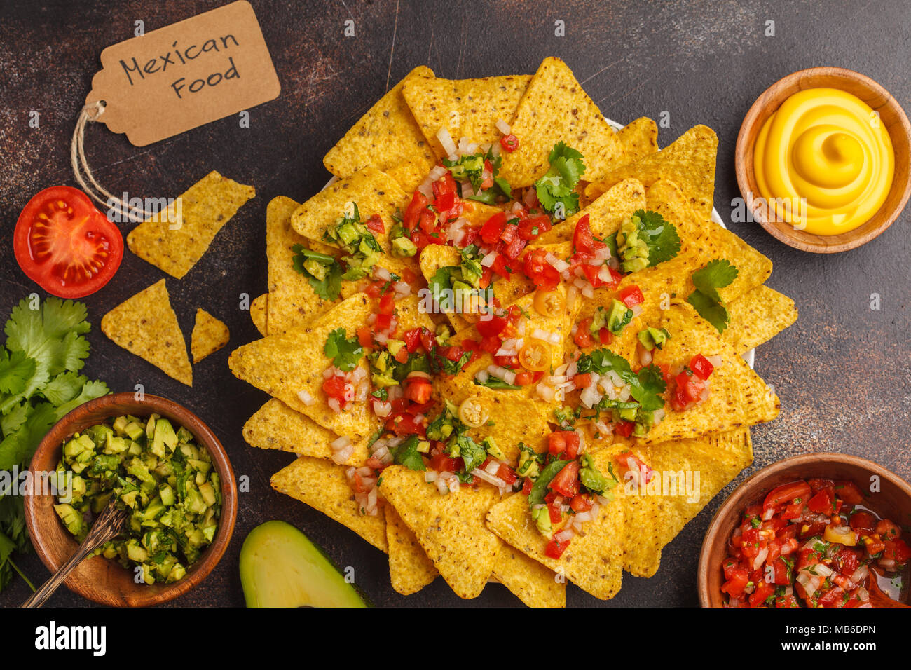 Mexican food concept. Nachos - yellow corn totopos chips with various ...