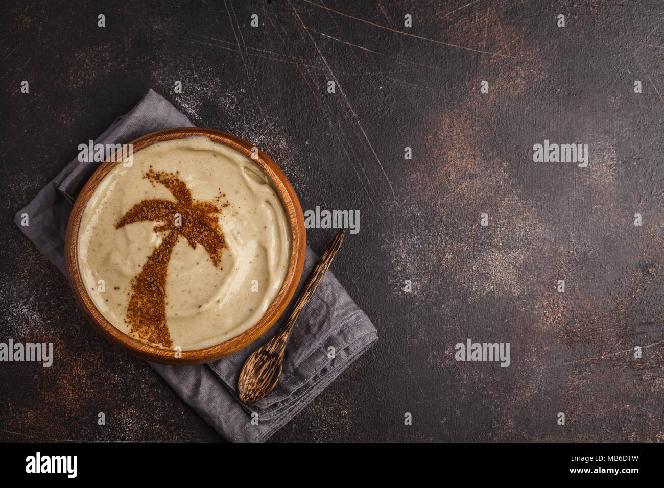 Vegan banana smoothie bowl with a palm tree carob decoration. Vegan ...