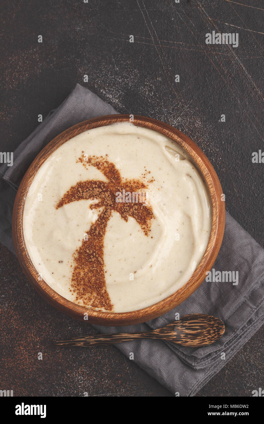 Vegan banana smoothie bowl with a palm tree carob decoration. Vegan ...