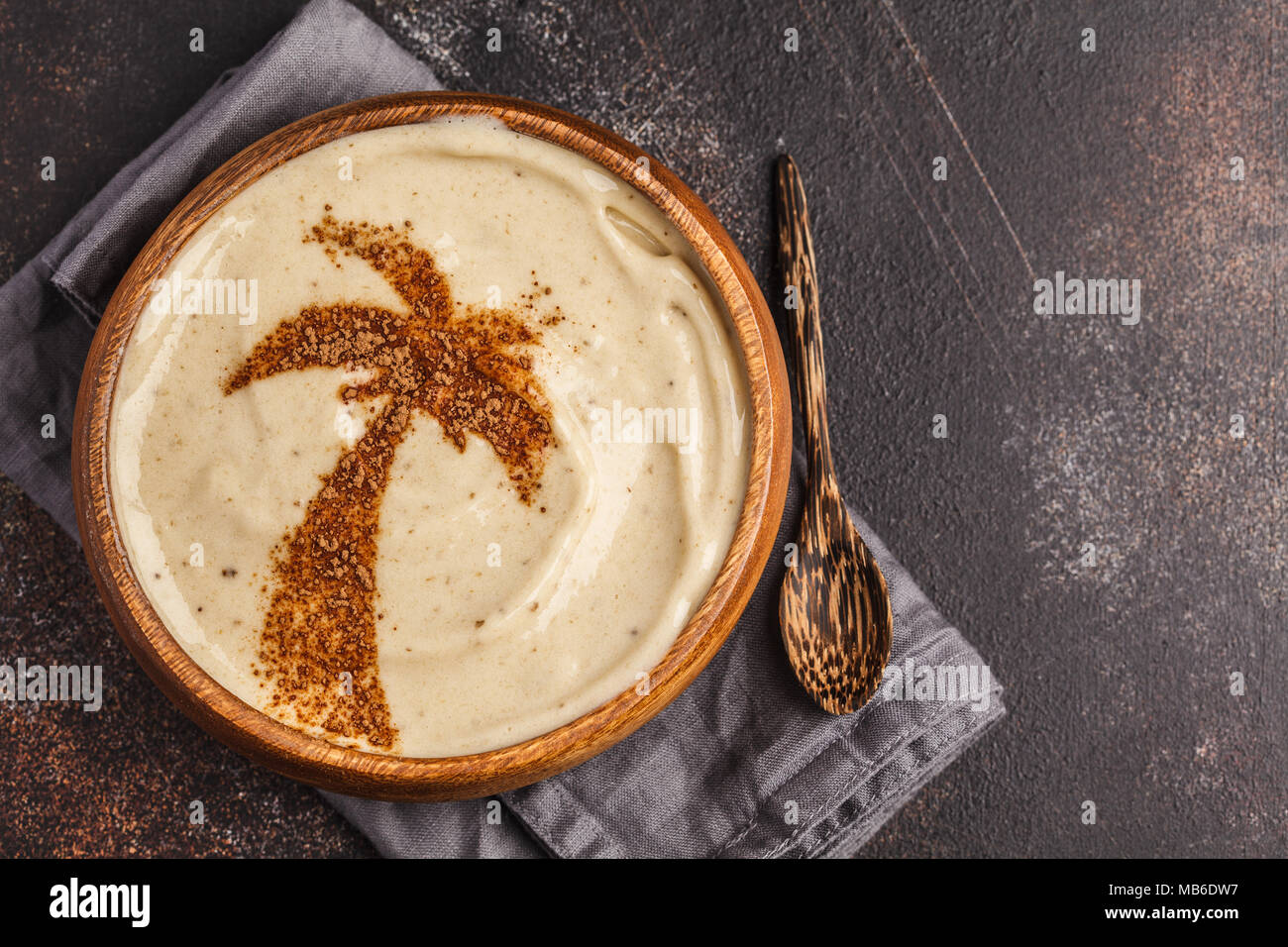 Vegan banana smoothie bowl with a palm tree carob decoration. Vegan ...