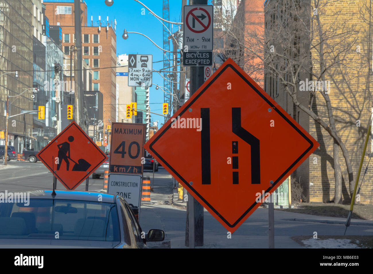 Construction signs indicating a lane closure, workmen and a speed limit ...