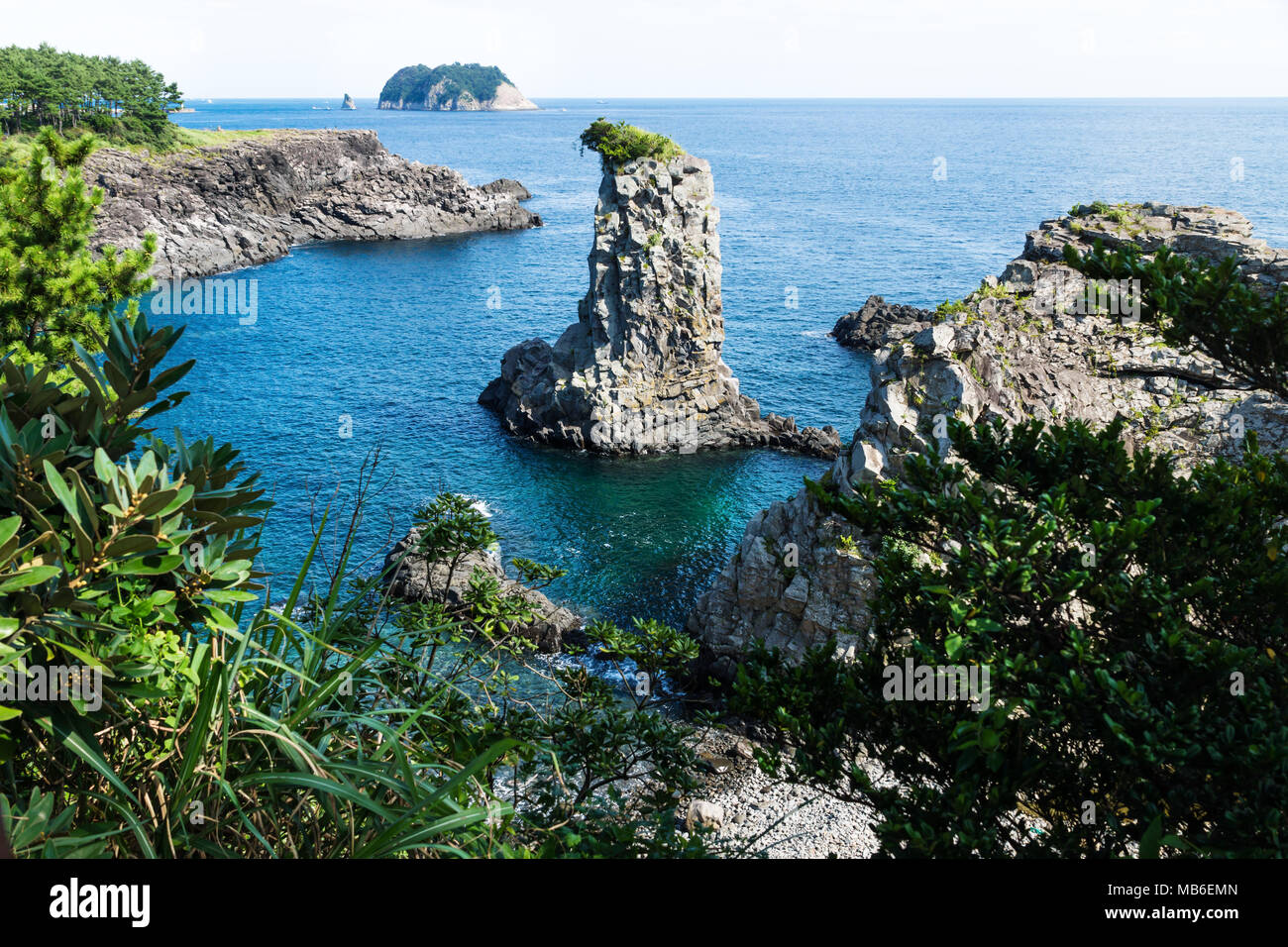 Rock formation Oedolgae surrounded by cliffs and forest in the ocean at ...