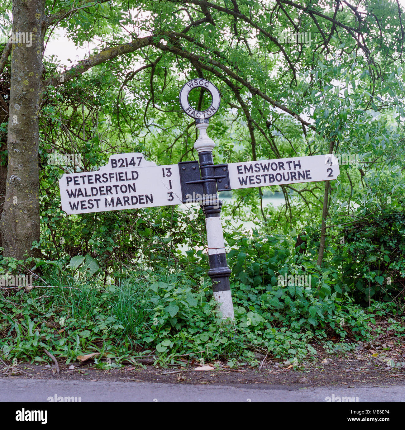 Old fashioned road direction signpost in Racton, in West Sussex ...