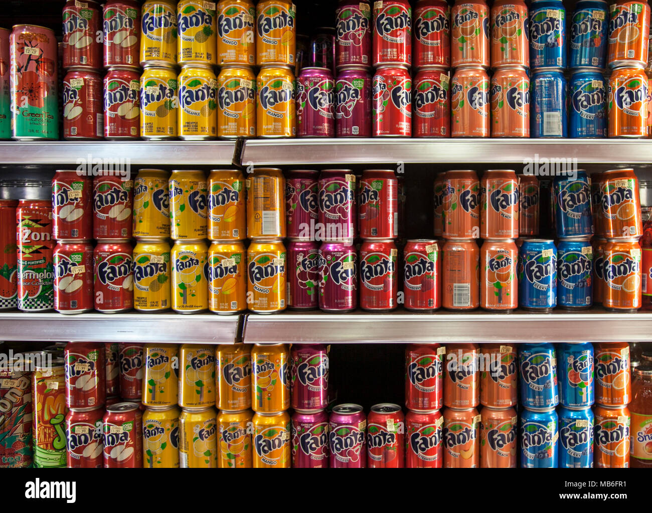 Refrigerated cabinet with cans of soft drinks, soda drink, beverage ...