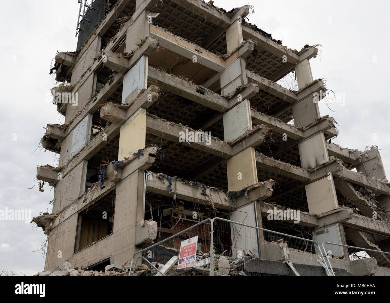 Partly demolished reinforced concrete building and concrete rubble on ...
