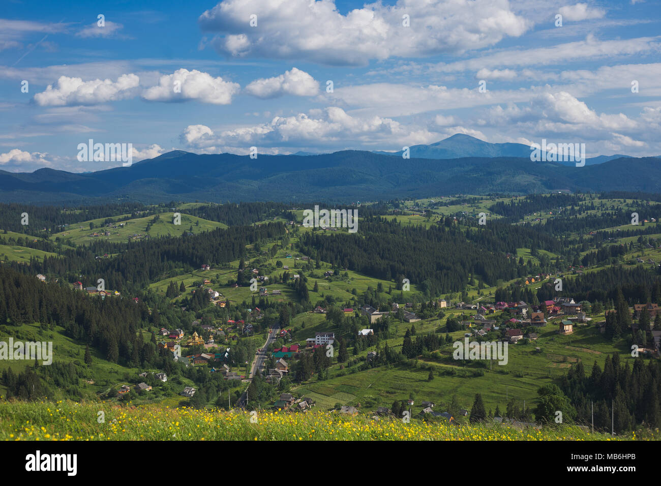 View from above at country village in valley down hill. Beautiful rural ...
